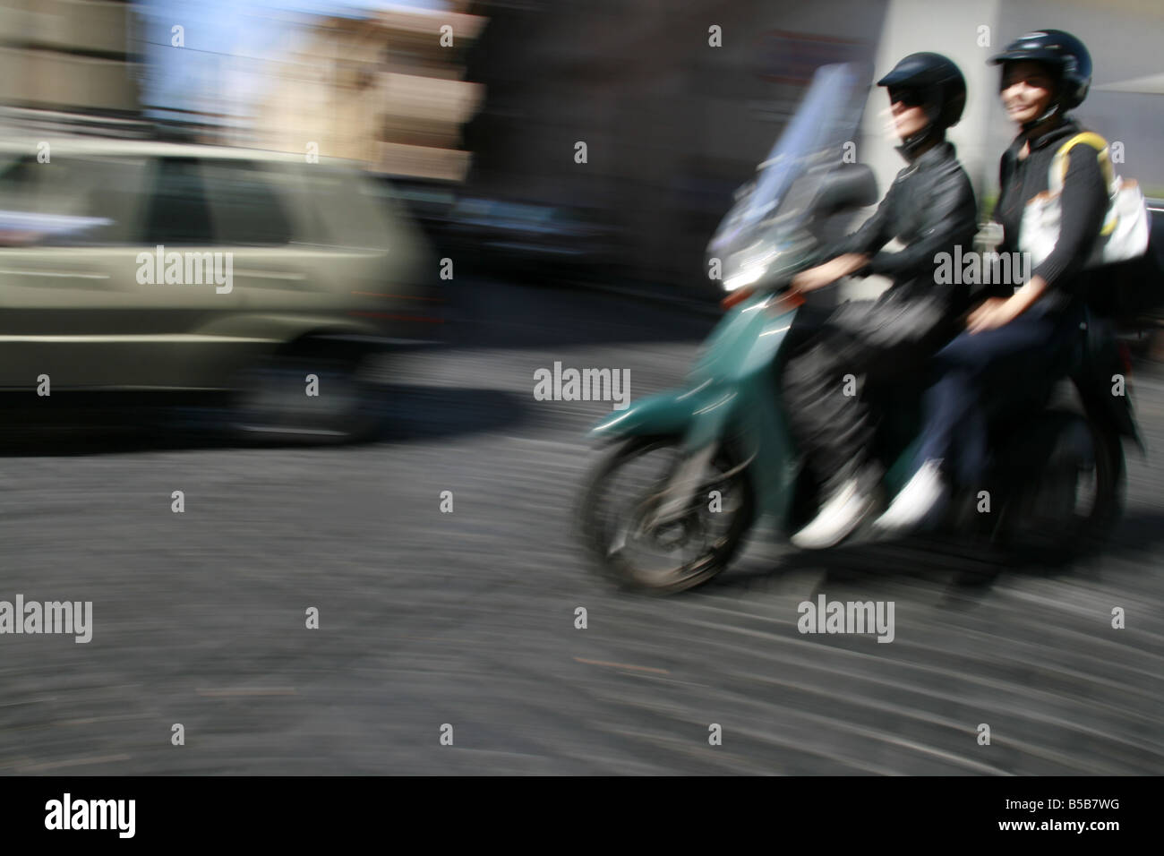 two people riding scooter moped in rome italy Stock Photo - Alamy