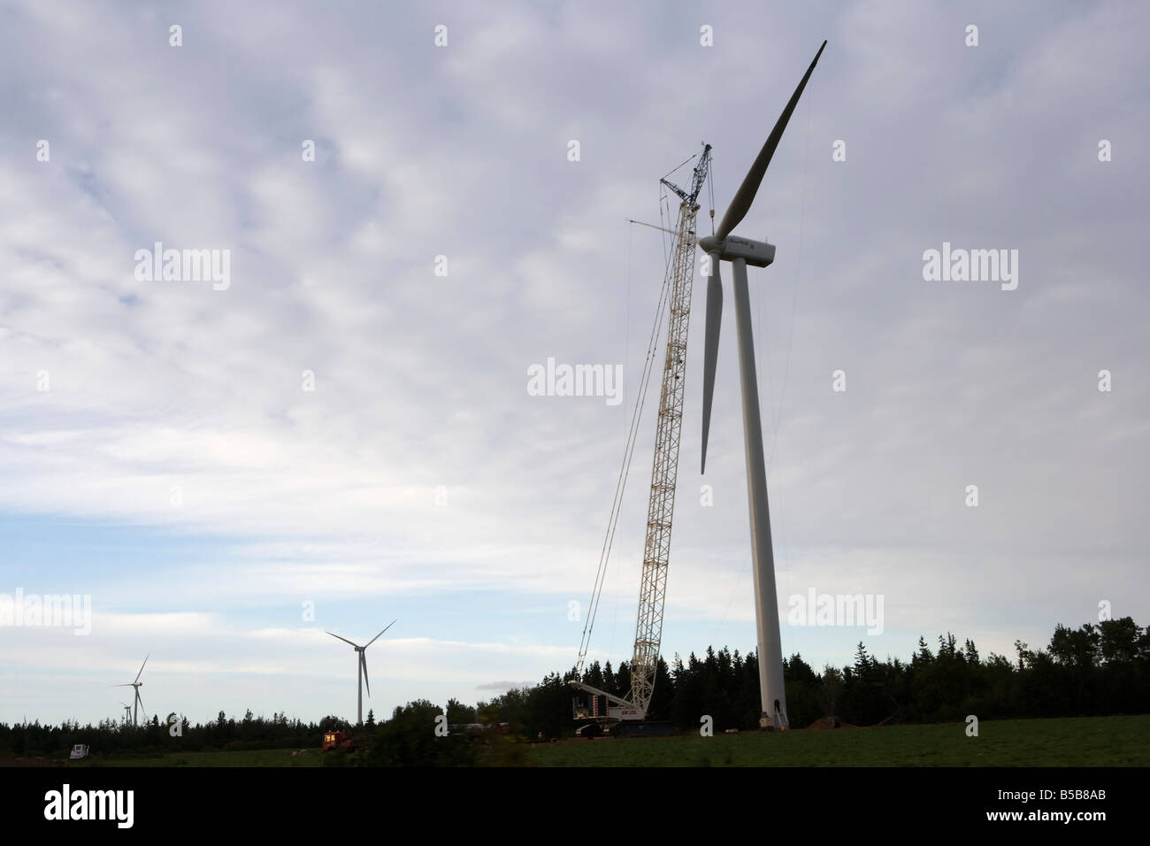 Workers assemble a wind turbine to produce green energy on Prince ...