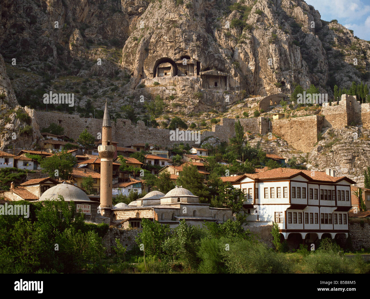 Restored castle walls and burial chambers from around 300 BC above ...