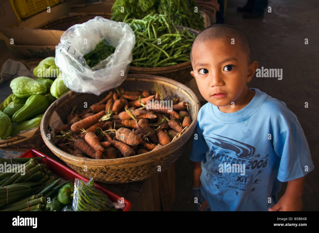 Little boy vendor at vegetable stall in food market, Bontoc, The ...
