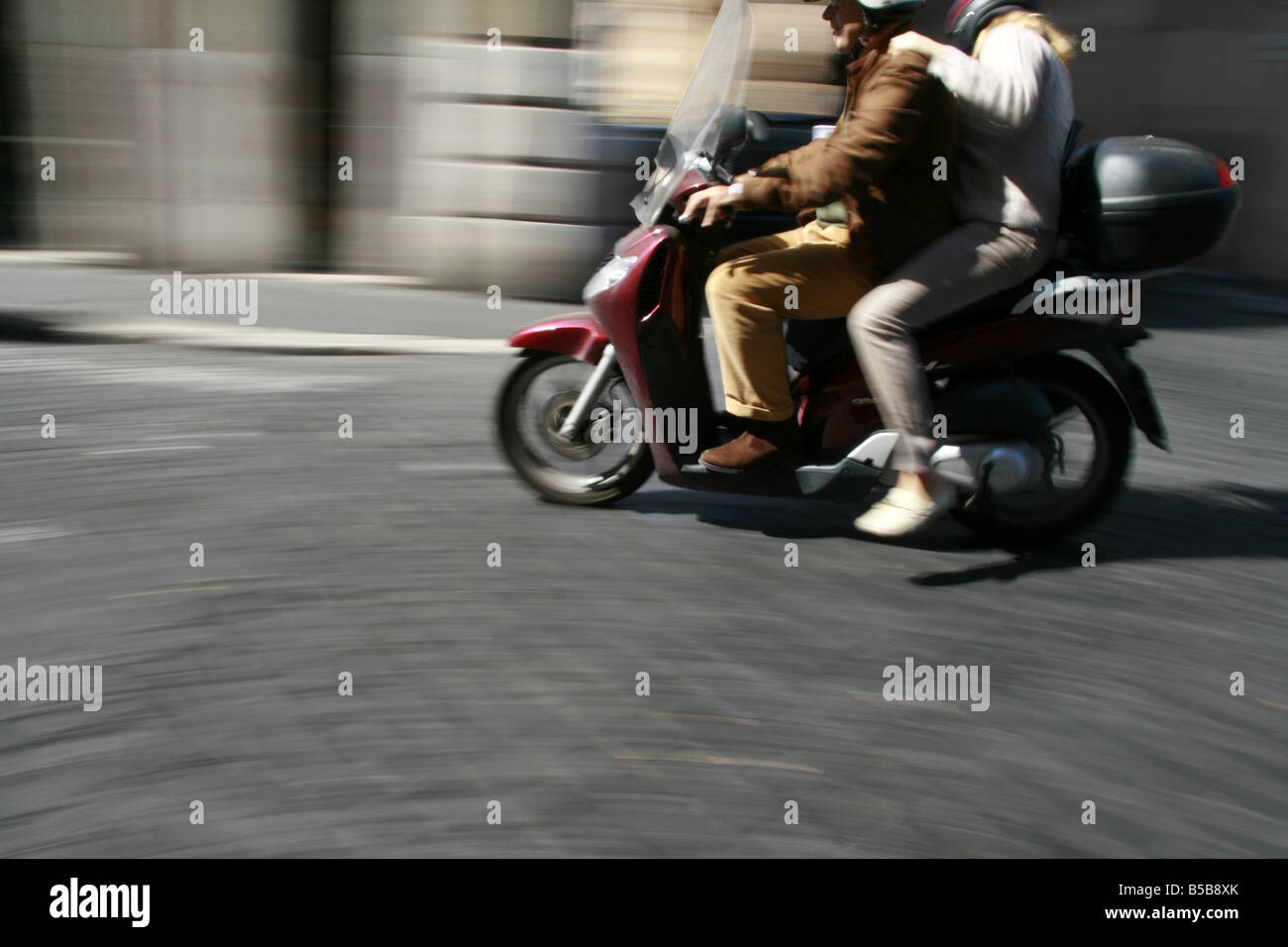 two people riding scooter moped in rome italy Stock Photo - Alamy