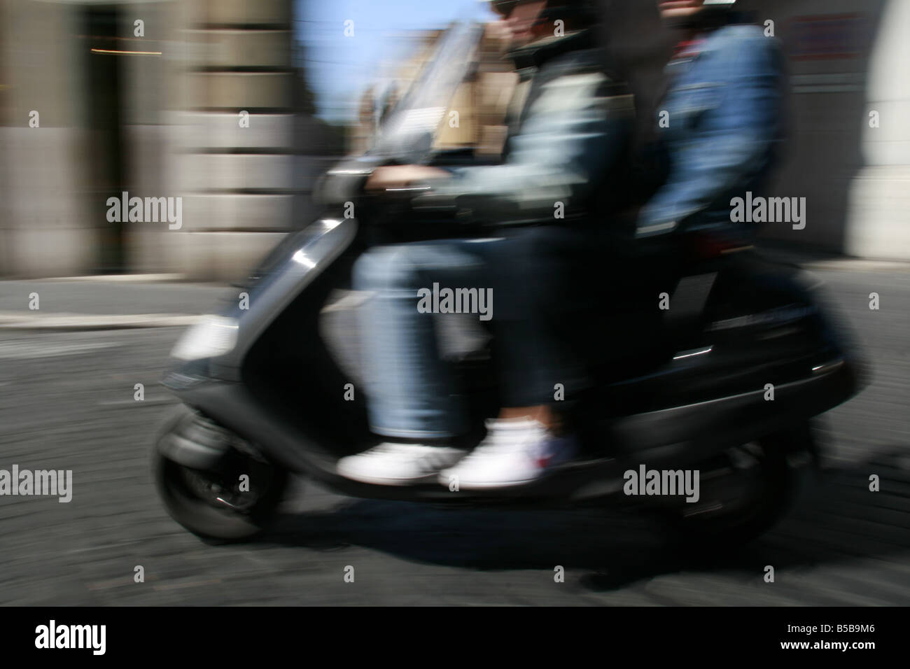 two people riding scooter moped in rome italy Stock Photo - Alamy