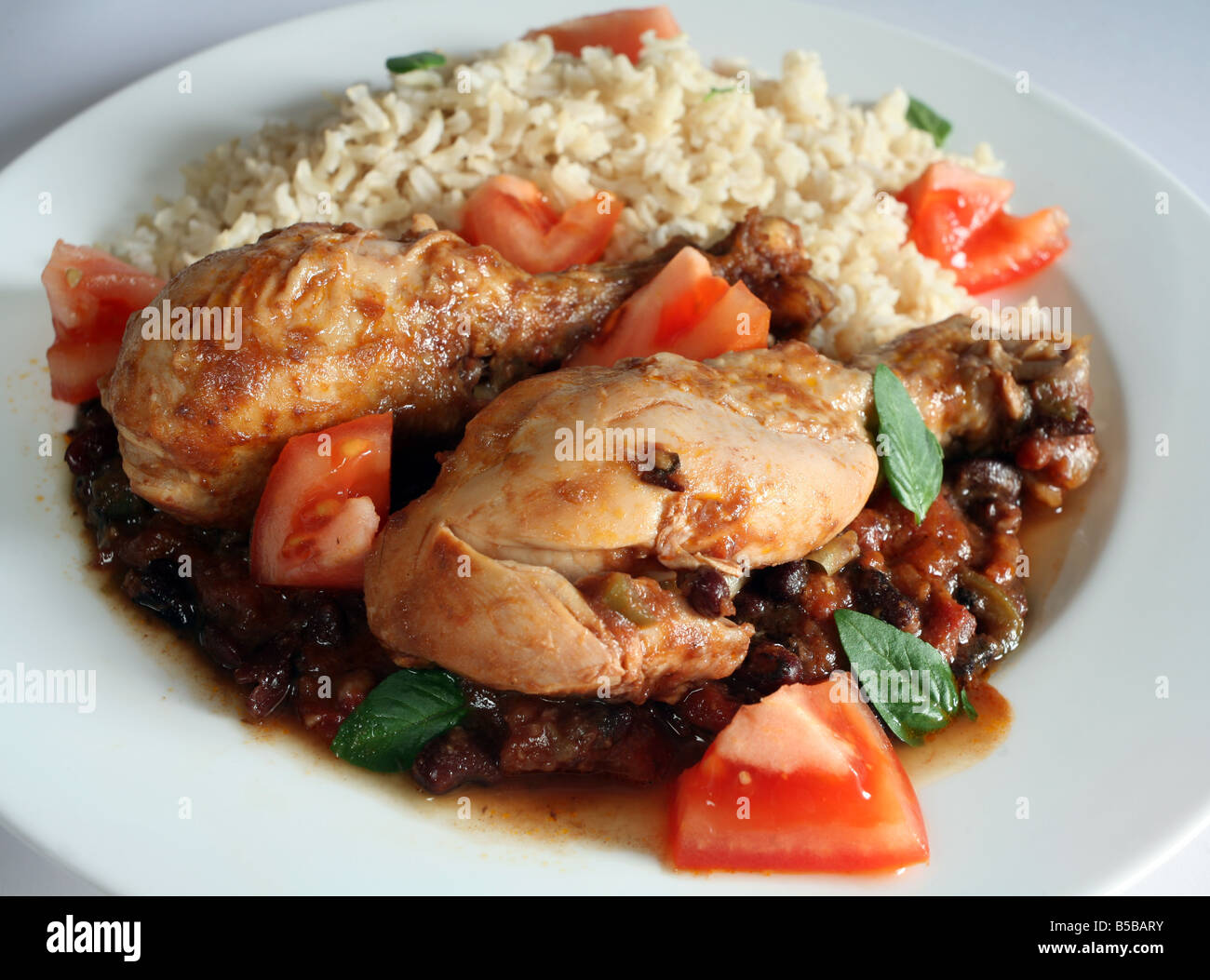 Traditional Cuban chicken drumsticks in black bean and tomato sauce ...