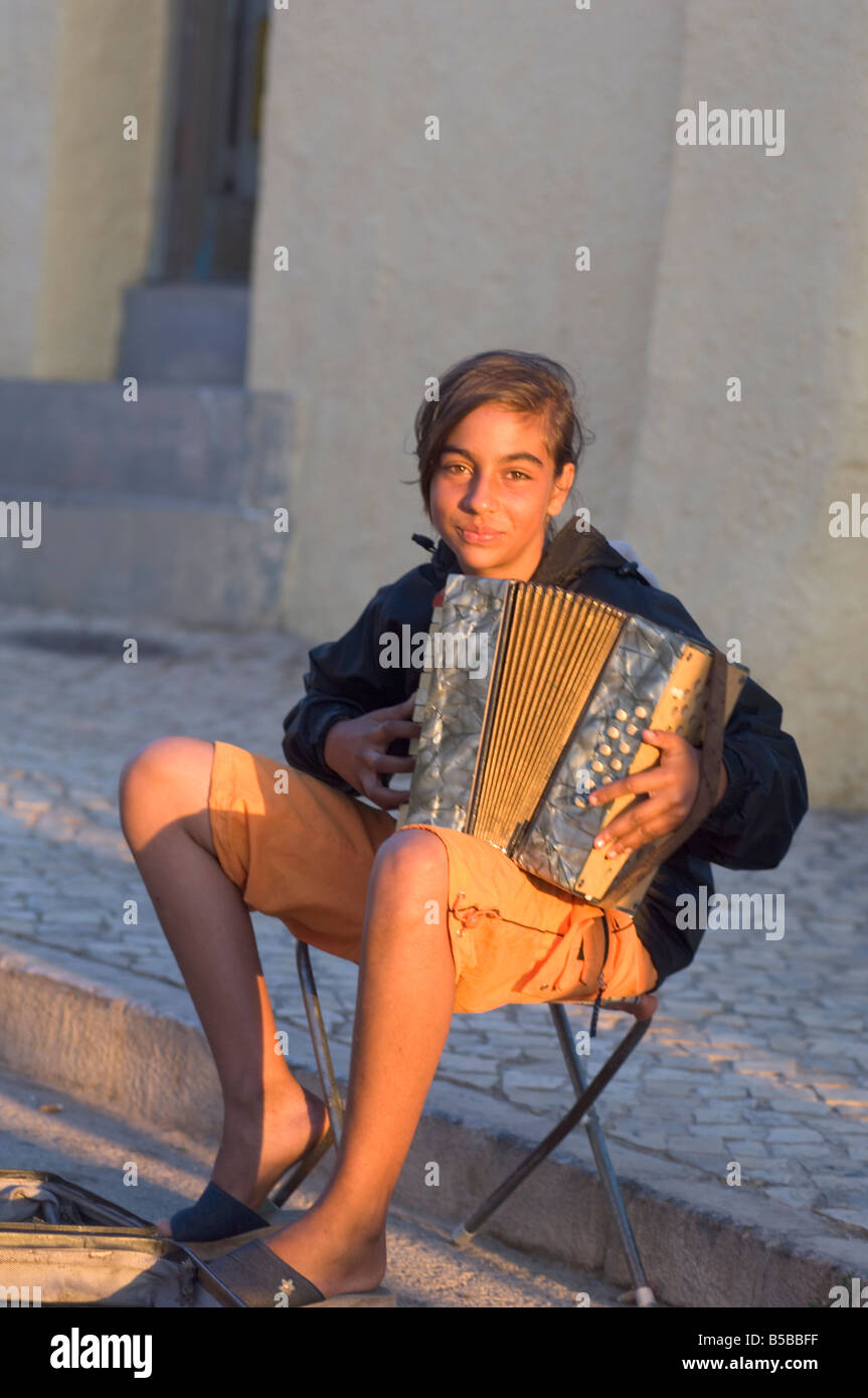 Gypsy girl playing piano accordion, Alvor, Algarve, Portugal, Europe ...