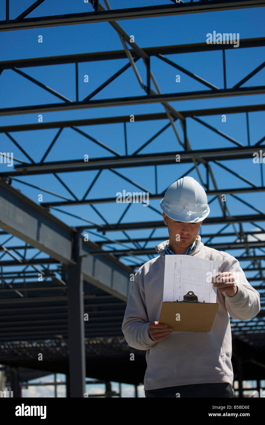 Engineer with clipboard on construction site Stock Photo - Alamy