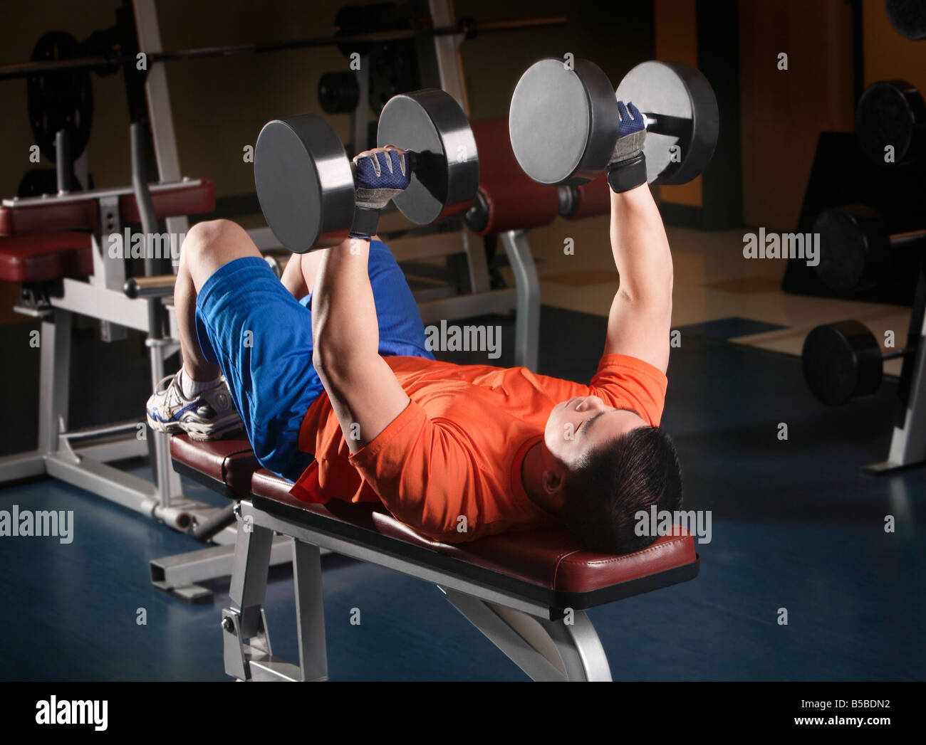Man lifting weights Stock Photo - Alamy