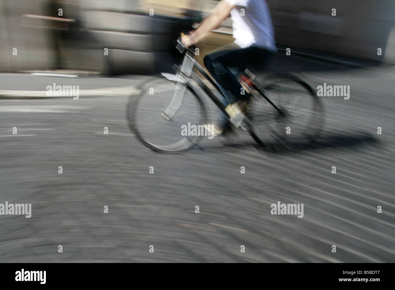 one person riding bike in city street Stock Photo - Alamy