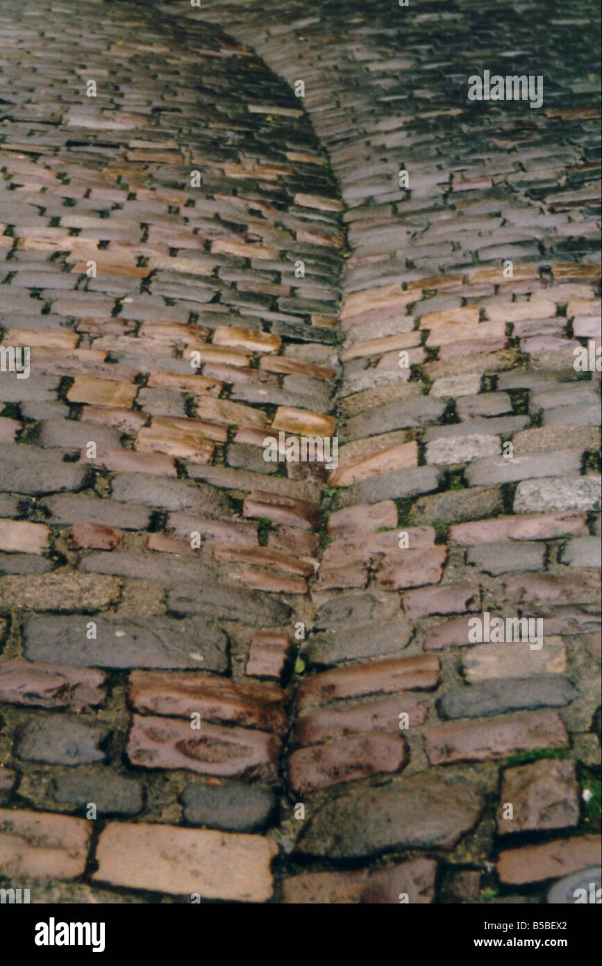 A cobblestoned street wet with rain Stock Photo - Alamy