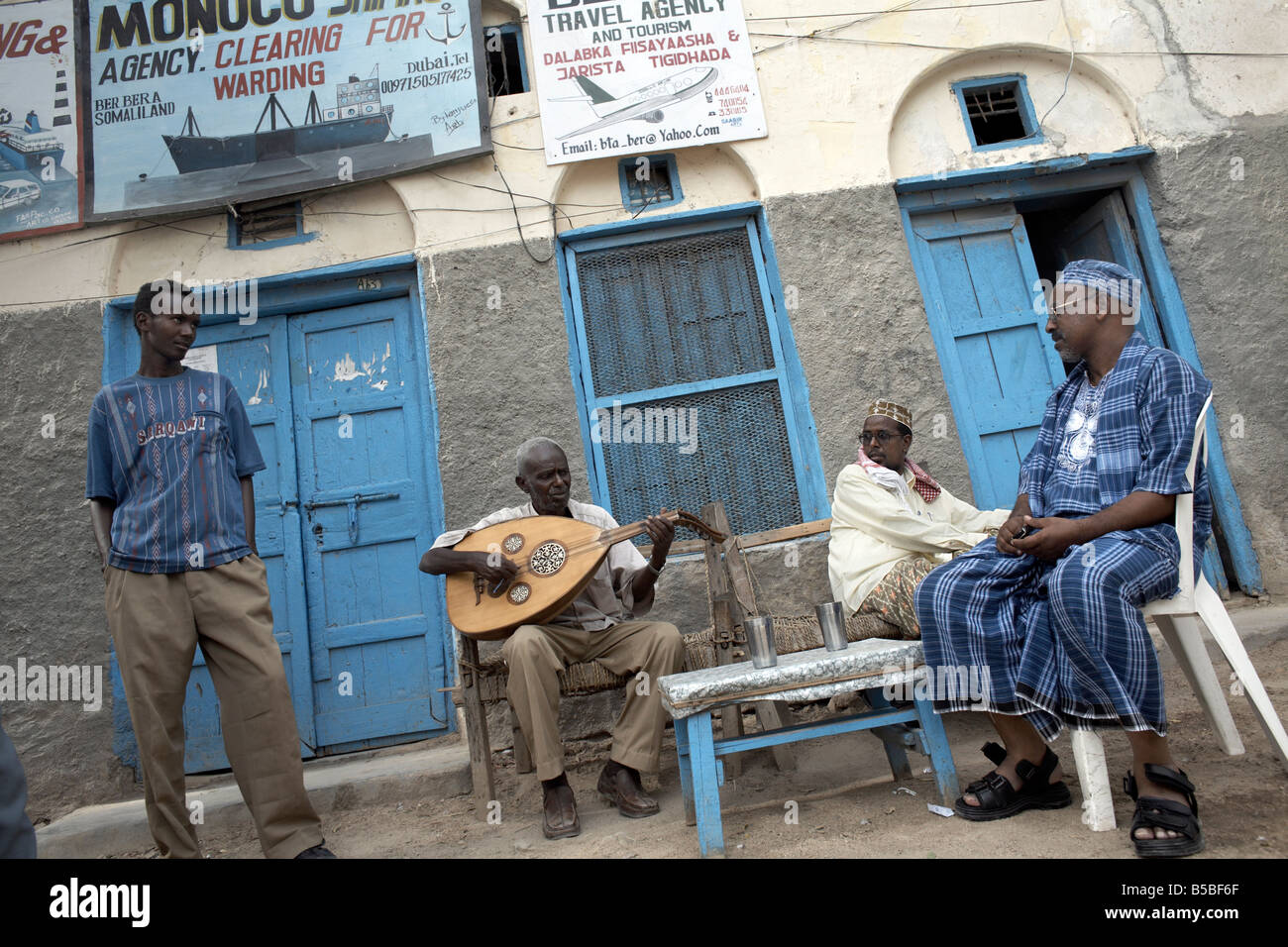 Locals relax with some traditional music, on the streets of Berbera ...
