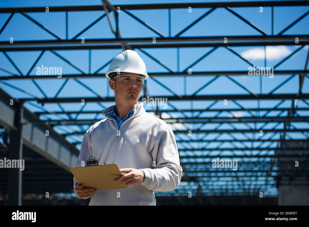 Engineer with clipboard on construction site Stock Photo - Alamy