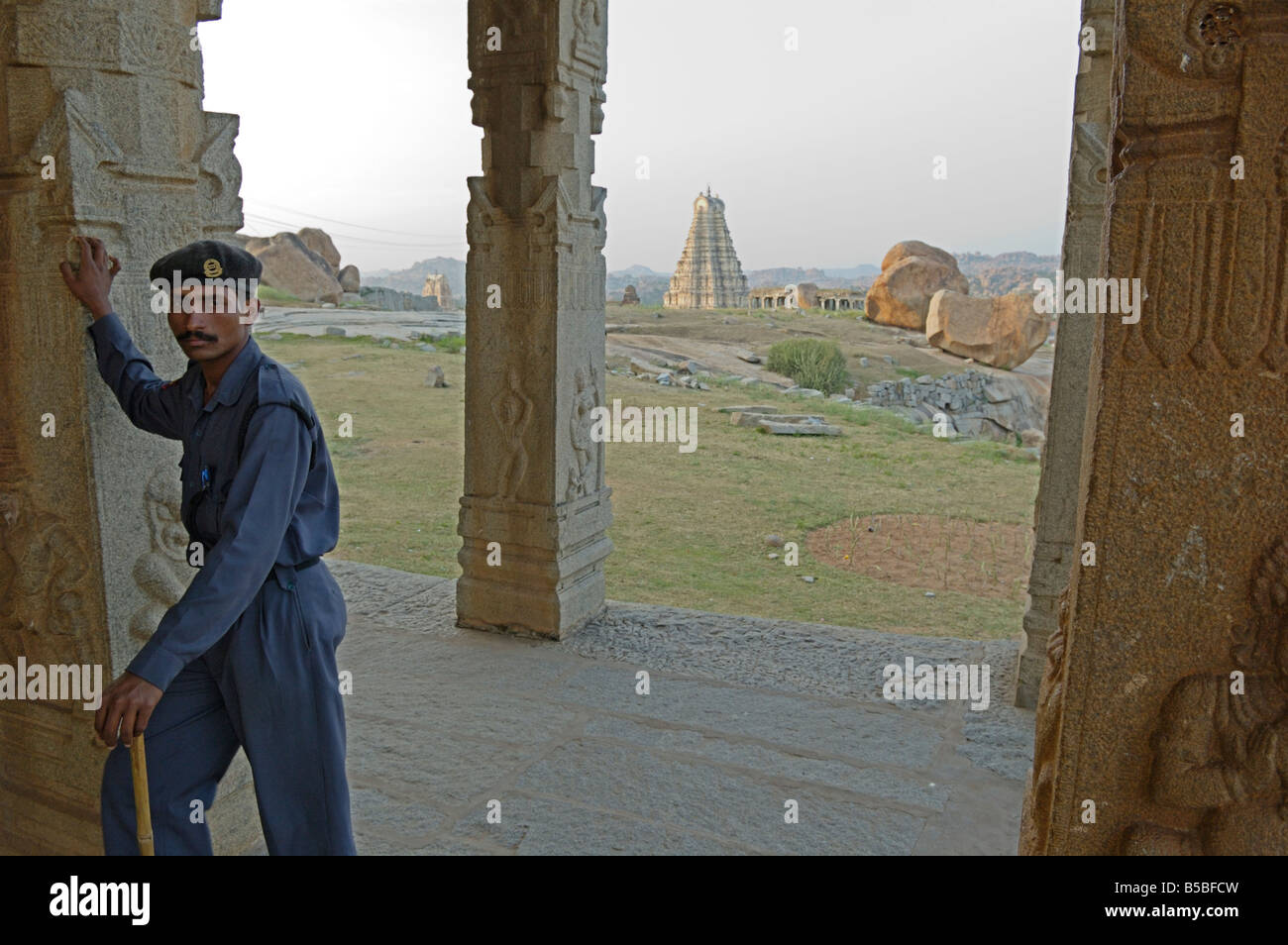 Indian watchman at Large Ganesha Temple. In the background is ...