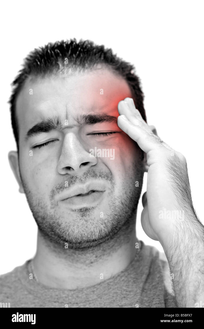 A young man grasps his head in anguish from pain or even stress Stock ...
