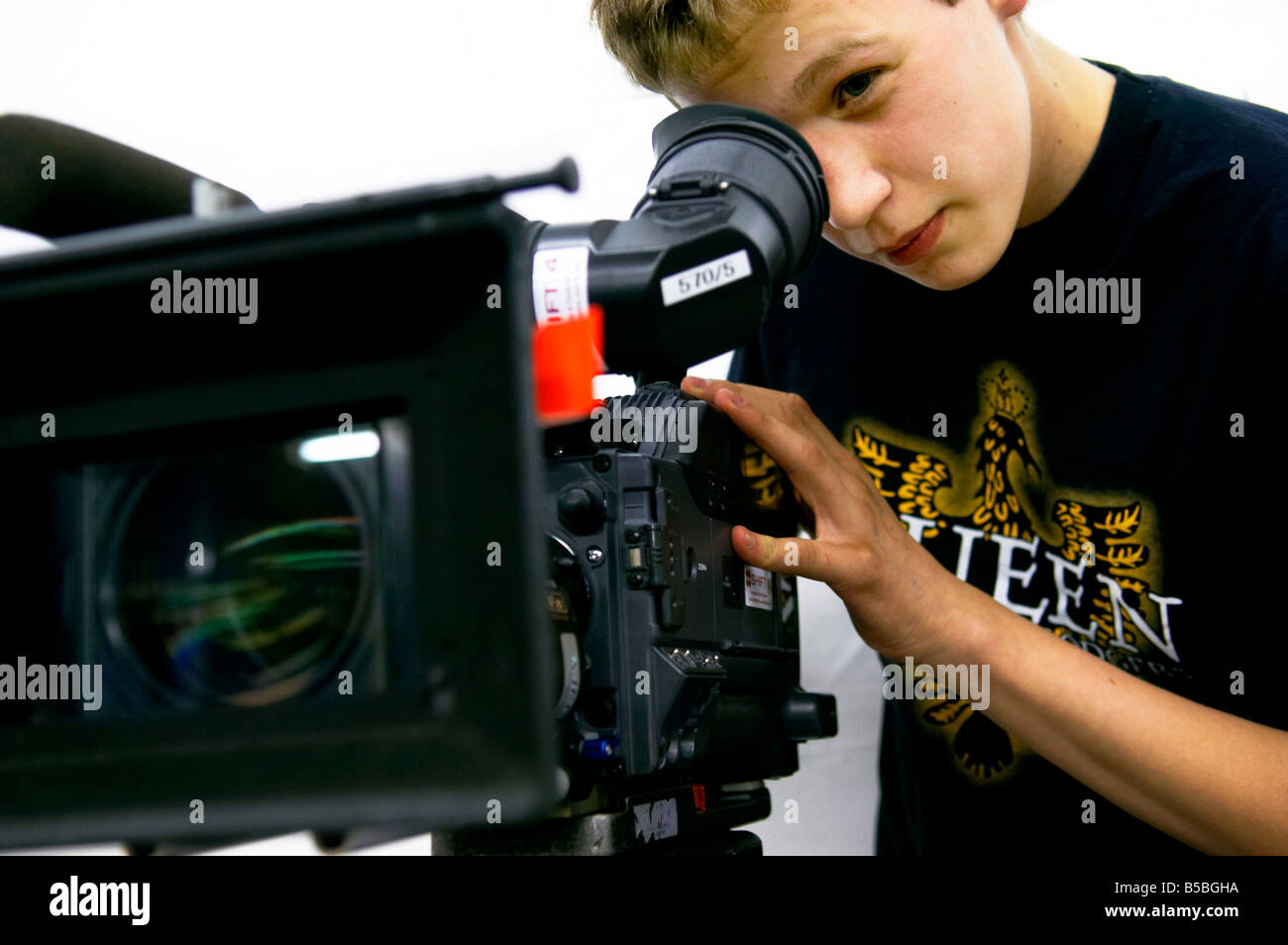 A teenage boy with a film camera in a studio Stock Photo - Alamy
