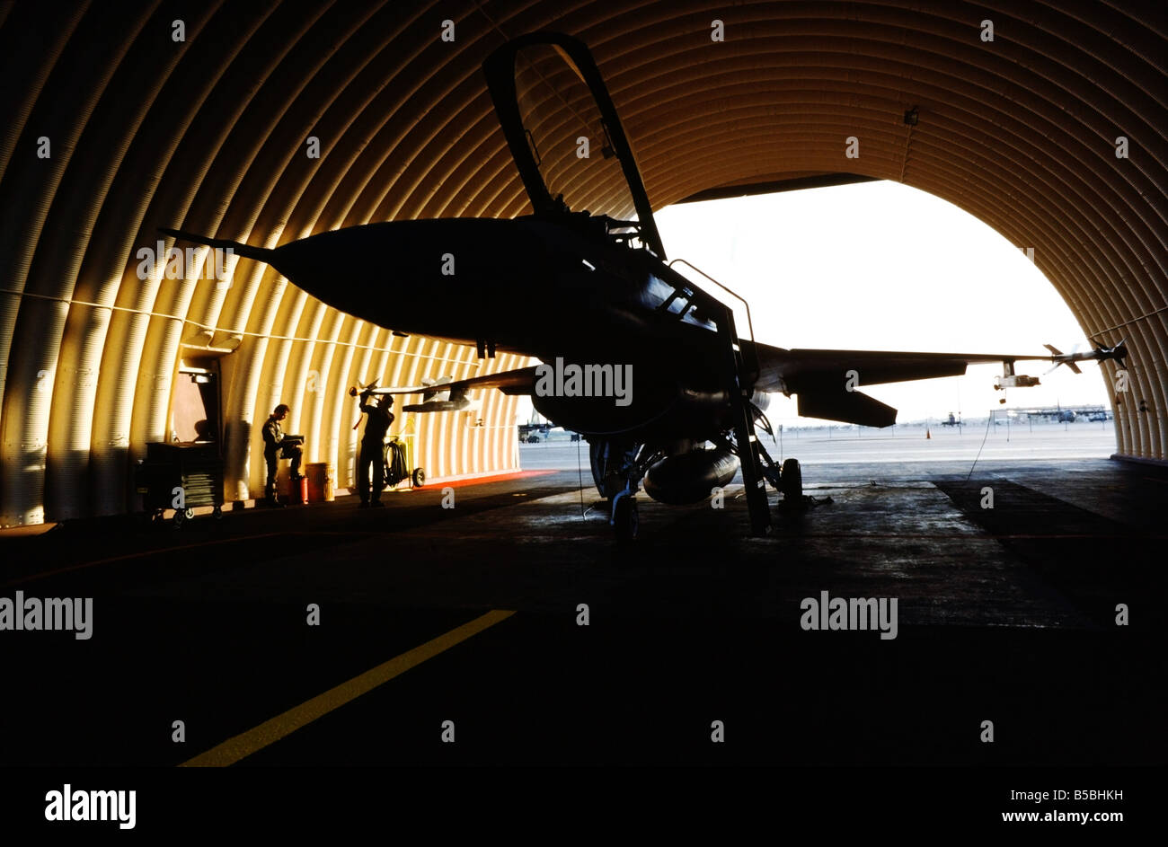US Air Force F-16 fighter plane with crew, on ground loading missles ...