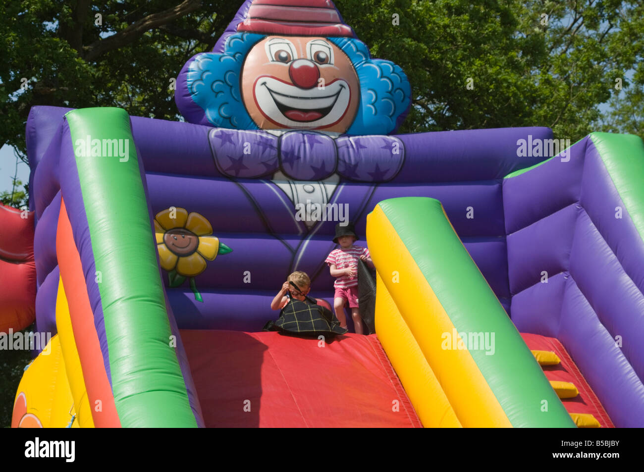 Two Boys Children kids playing On an Inflatable Slide Cowpie Rally ...