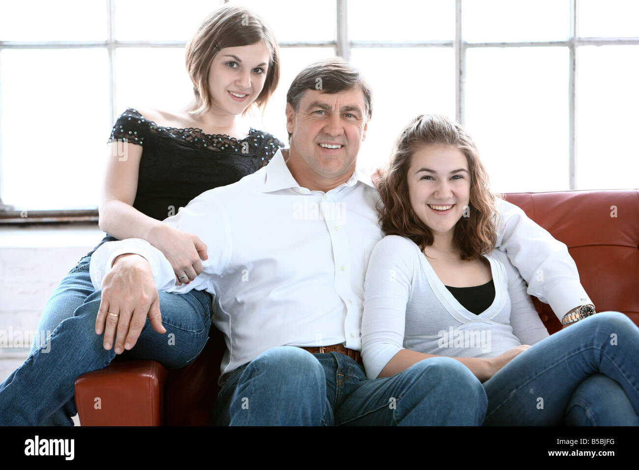 Family portrait of father with two daughters Stock Photo - Alamy