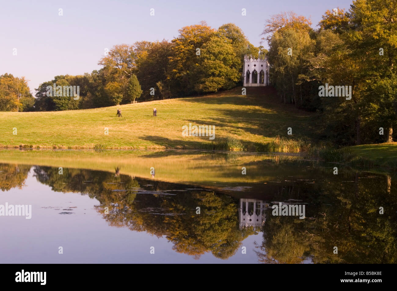 A Gothic folly reflected in the lake at Painshill Landscape Garden ...