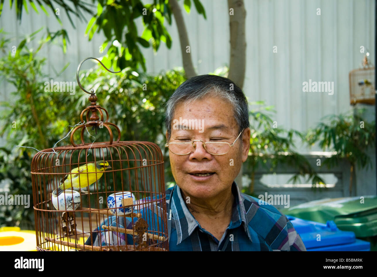 A man shows off his bird in the bird market, Yuen Po Street, Mong Kok ...