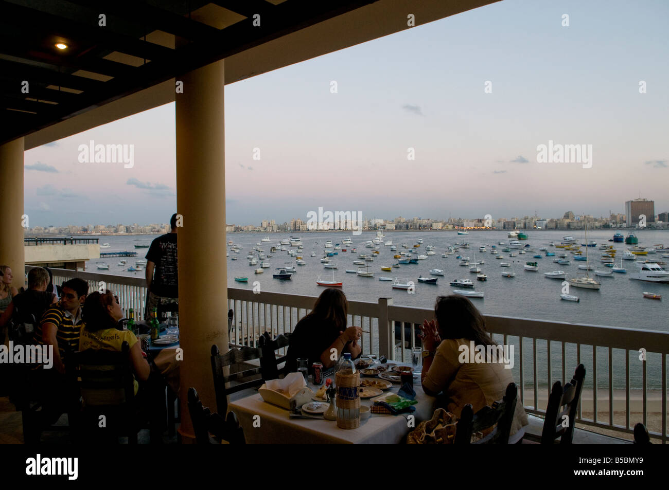 Locals dine at a fish restaurant in Alexandria Egypt Stock Photo - Alamy