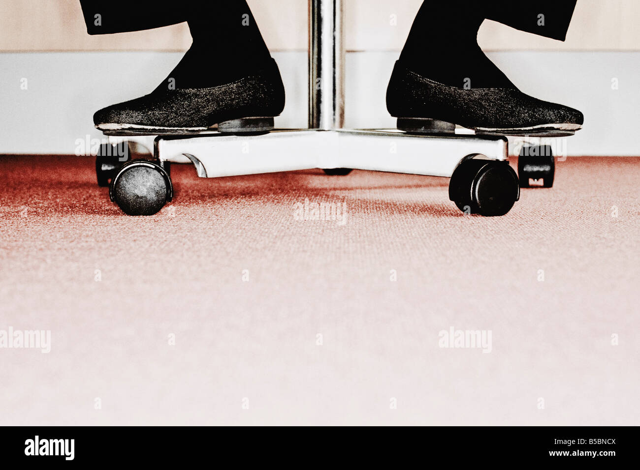 Woman s Feet On Base Of Office Chair Stock Photo - Alamy