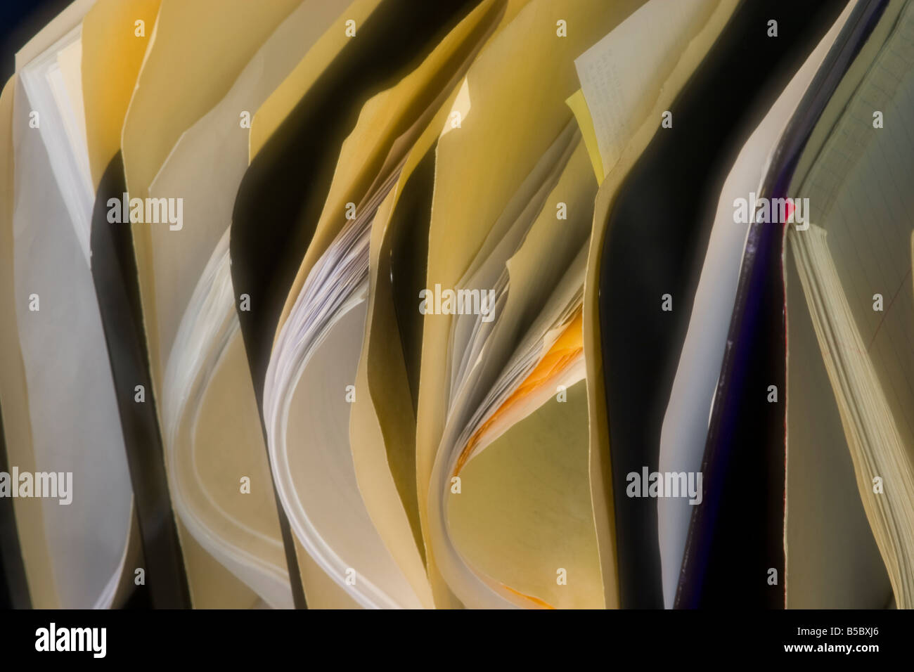 Close up of papers on a desk in an upright file Stock Photo - Alamy