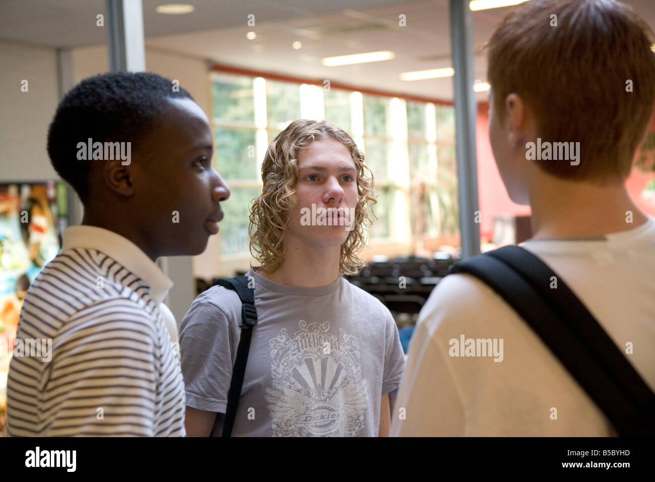 Teenage boys talking in the school hall Stock Photo - Alamy