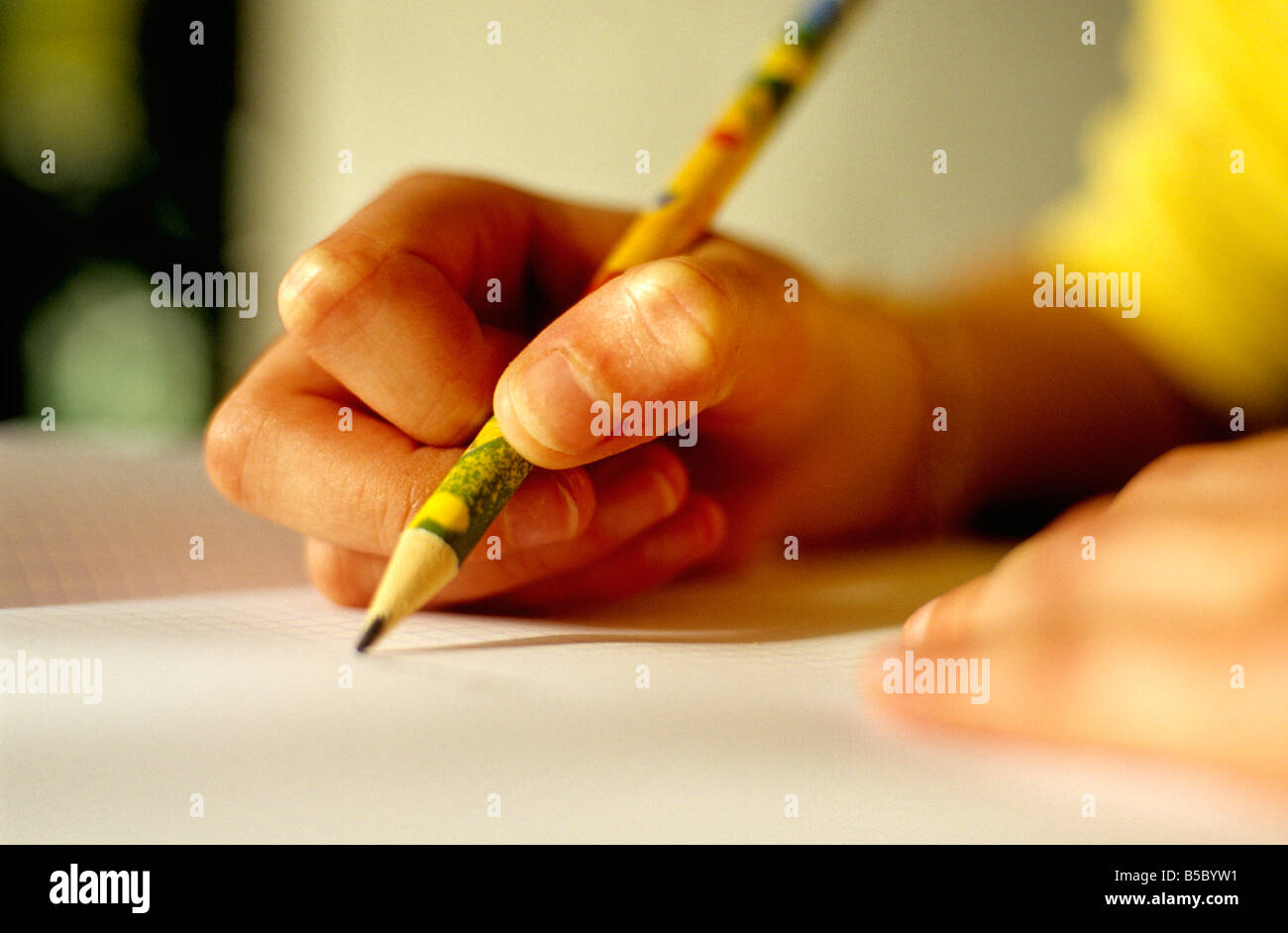 Young person writing or doing their homework Stock Photo - Alamy