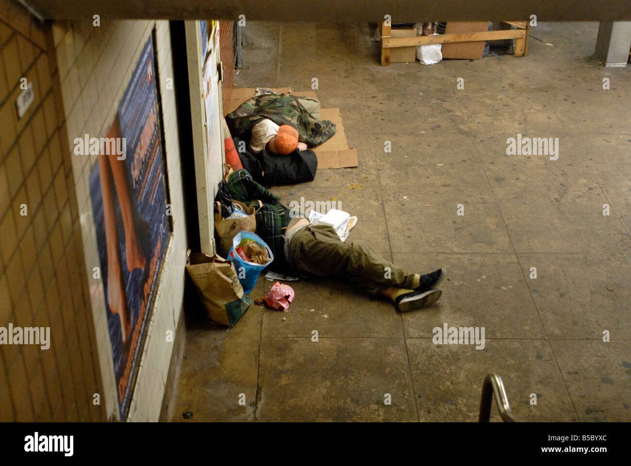 Homeless men camping out in the 23rd Street subway station in the New ...