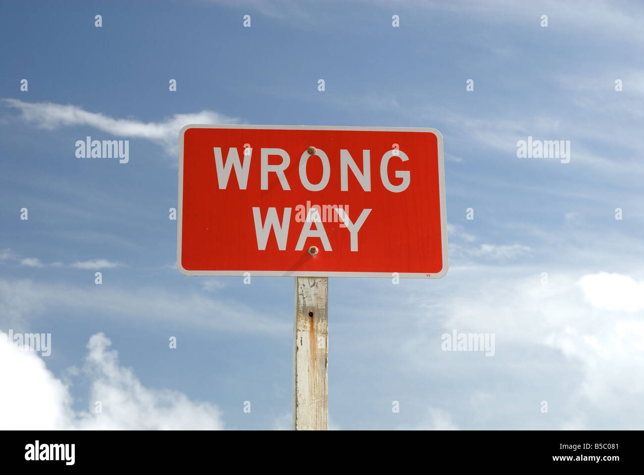 Wrong Way sign against blue sky Stock Photo - Alamy