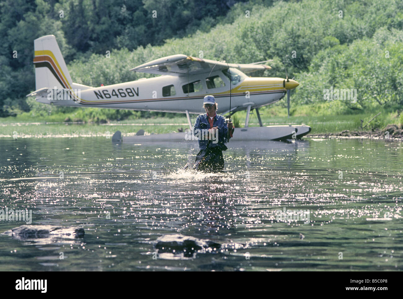 A fisherman arriving by float plane or bush plane catches migrating ...