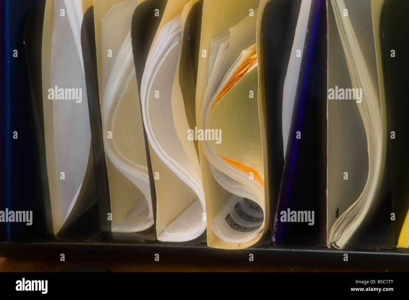 Close up of papers on a desk in an upright file Stock Photo - Alamy