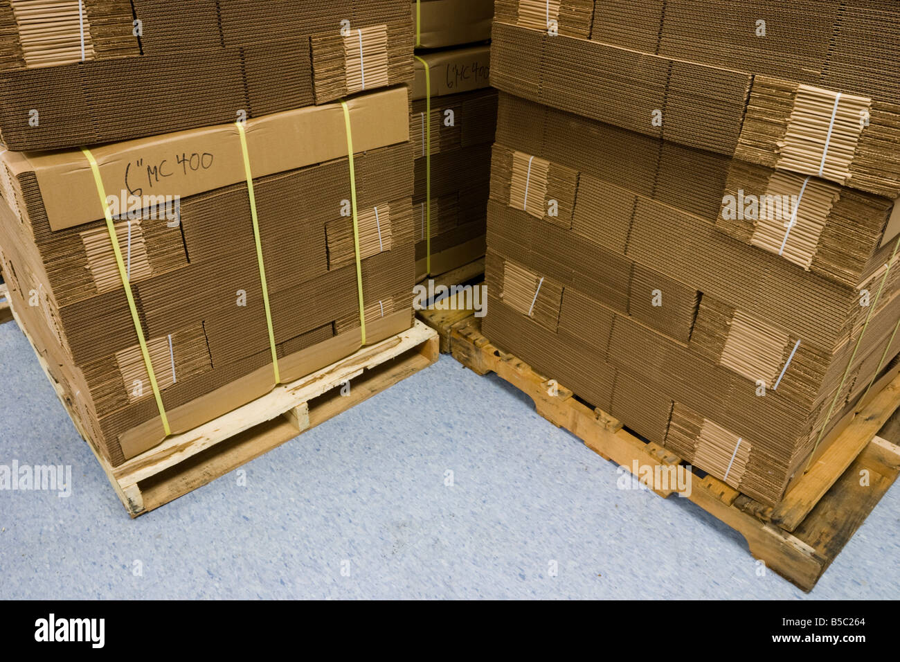 New flat cardboard boxes bundled together on wooden pallers Stock Photo ...