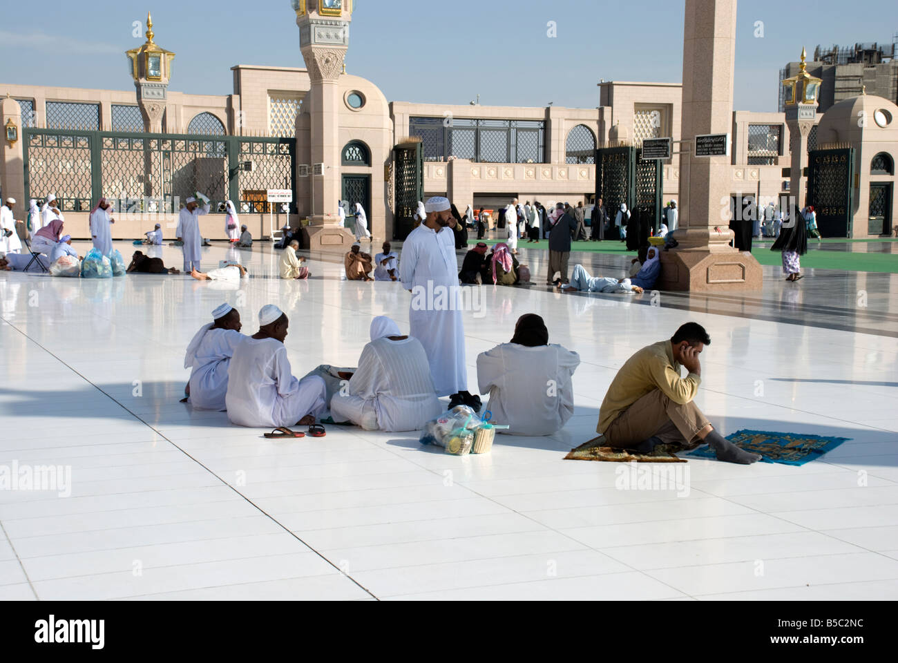 Muslim pilgrims sitting in the shadow in the courtyard of Masjid al ...