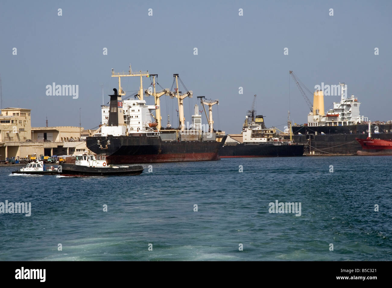 Port scene Dakar Senegal with tug and port pilot and vessels including ...
