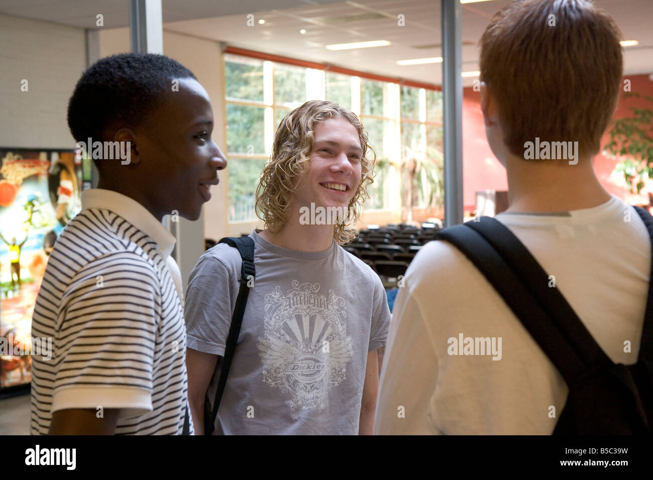 Teenage boys talking in the school hall Stock Photo - Alamy