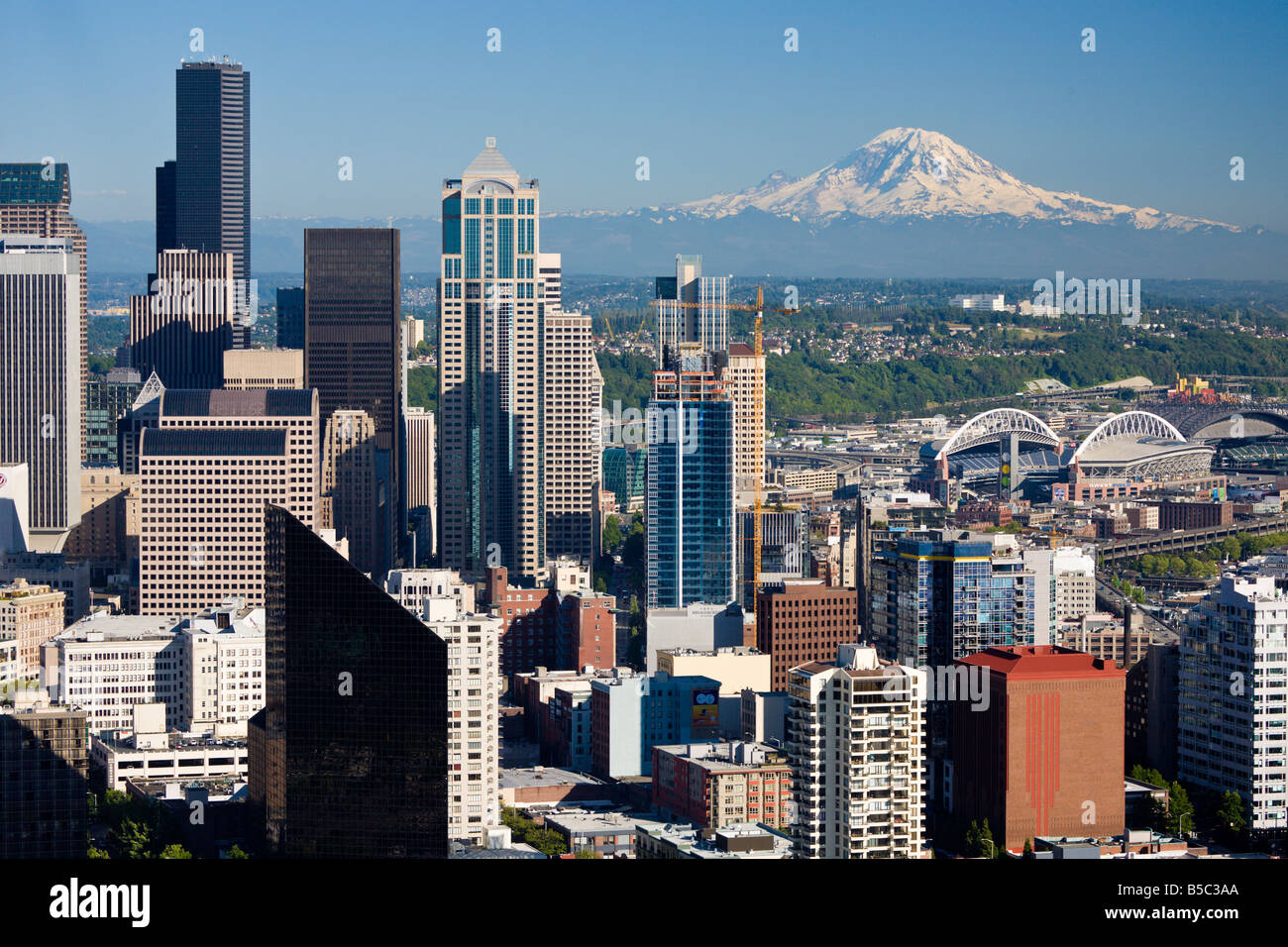 Mount Rainier rises behind the Seattle downtown cityscape Stock Photo ...