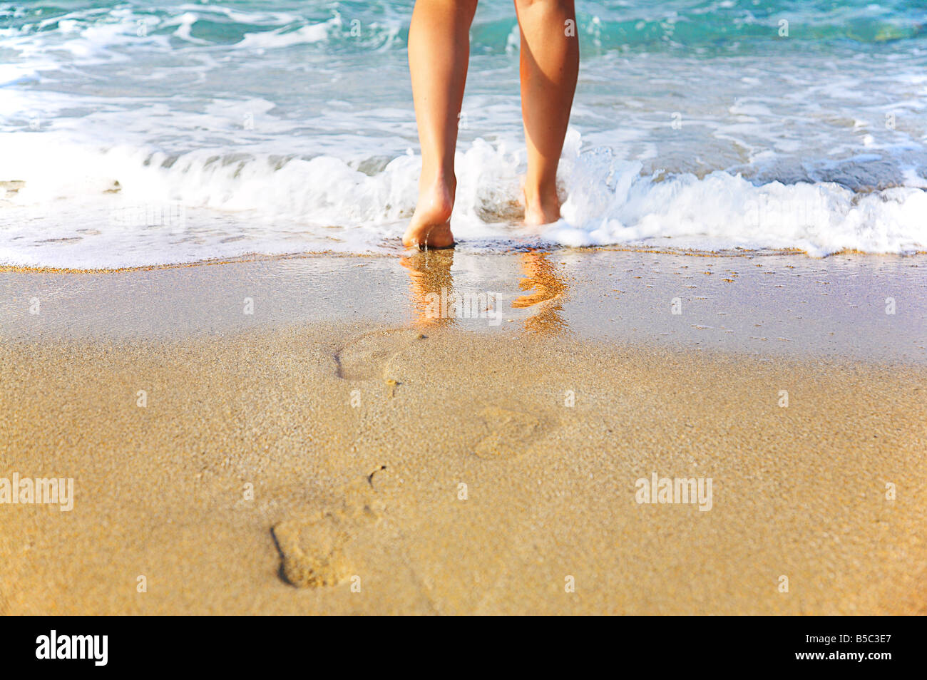 Woman's legs going to sea Stock Photo - Alamy