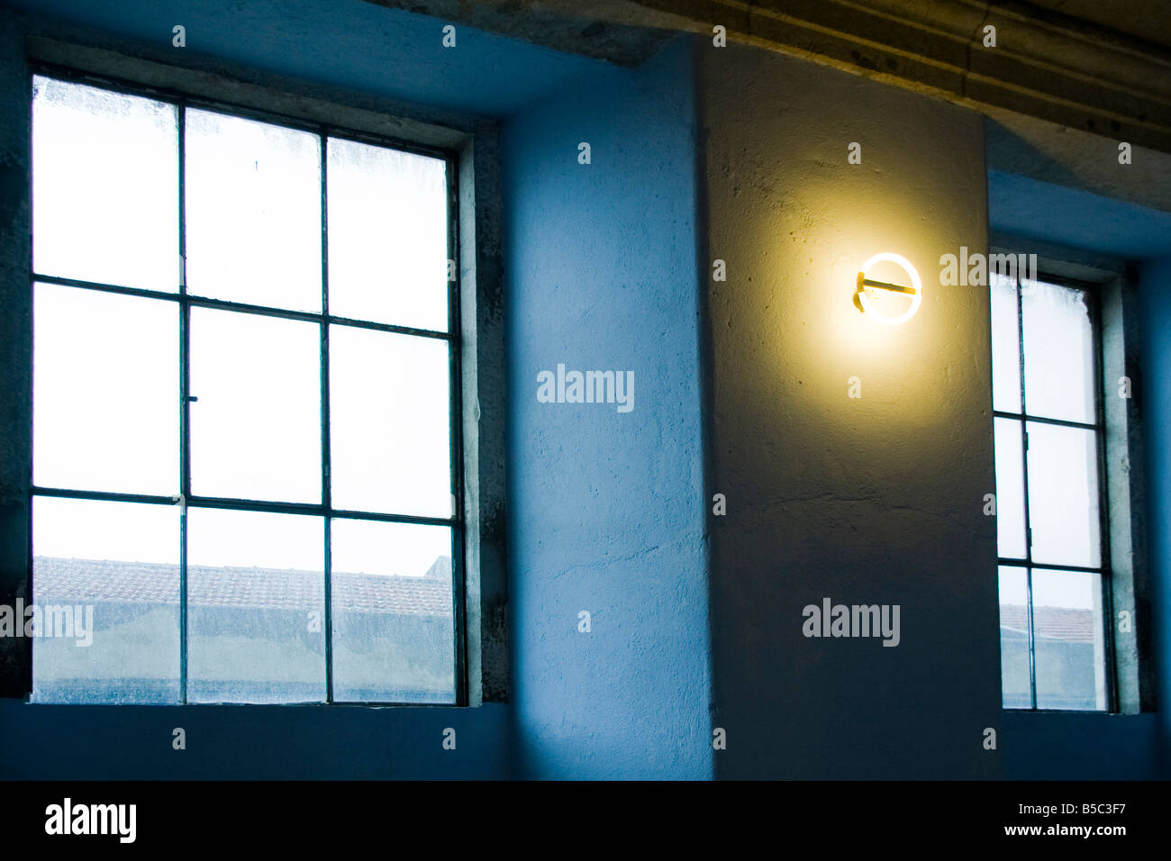 windows on old factory building with circular lamp Stock Photo - Alamy