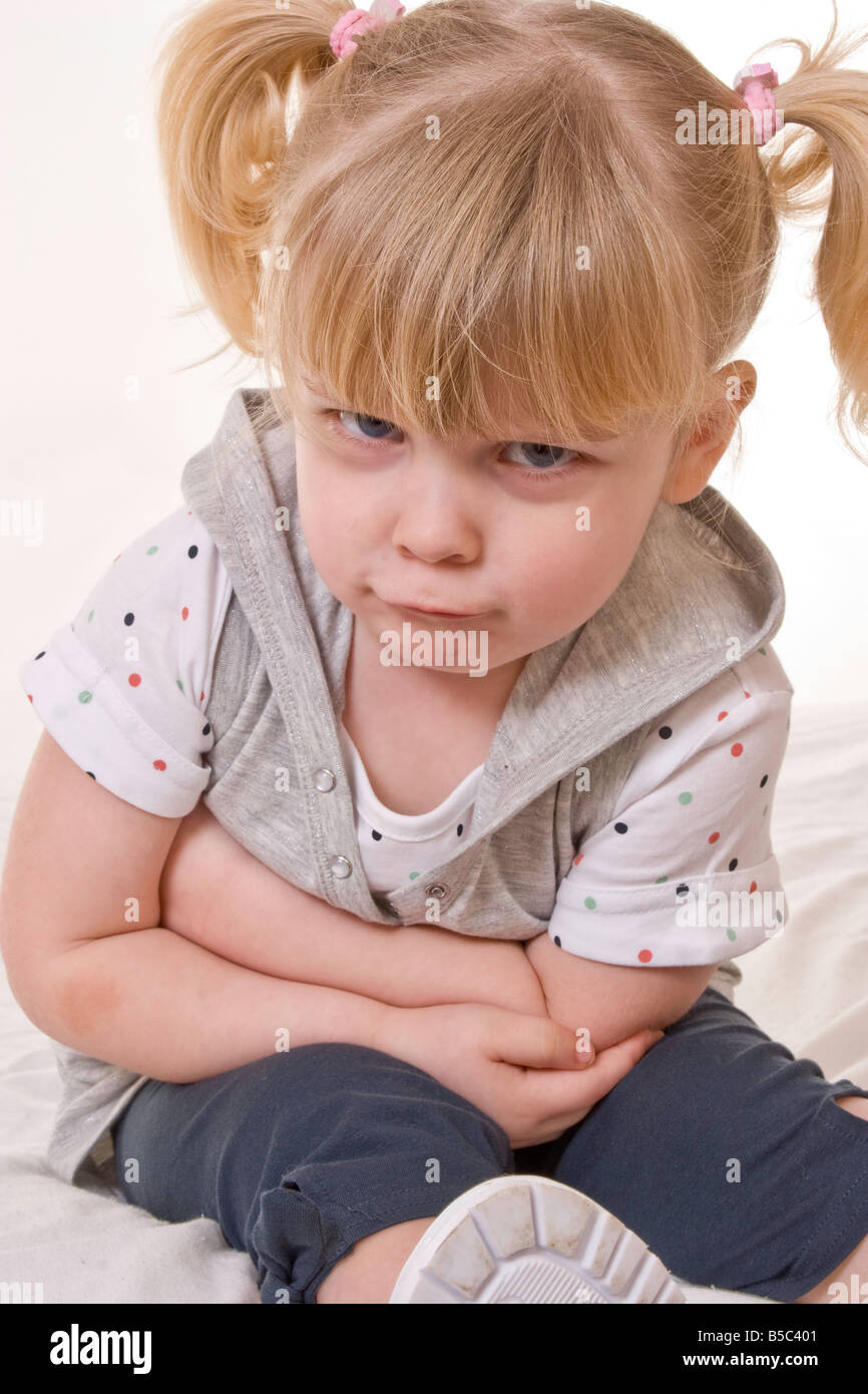 child with folded arms scowling Stock Photo - Alamy