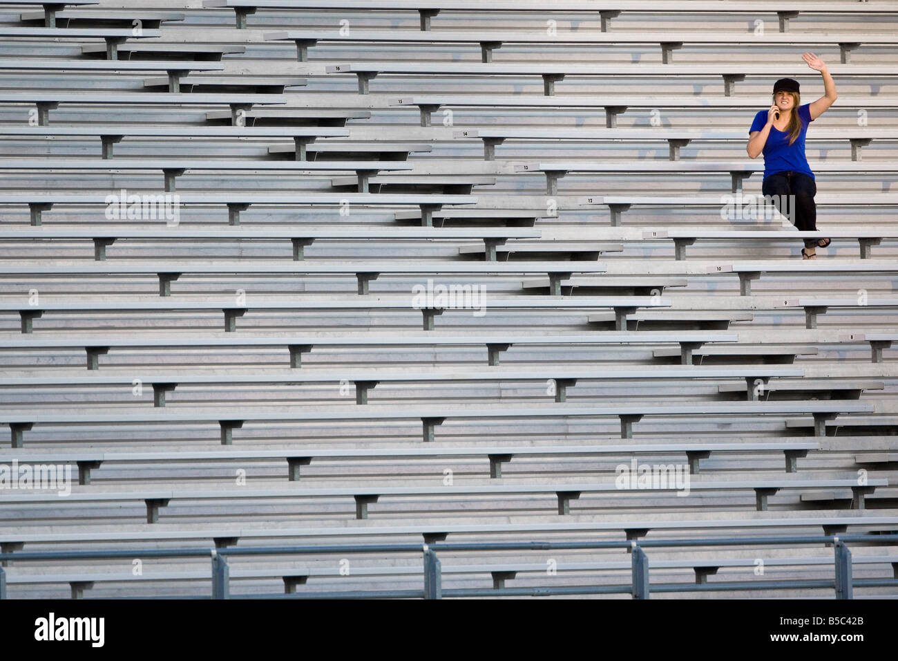 Woman in the bleachers Stock Photo - Alamy