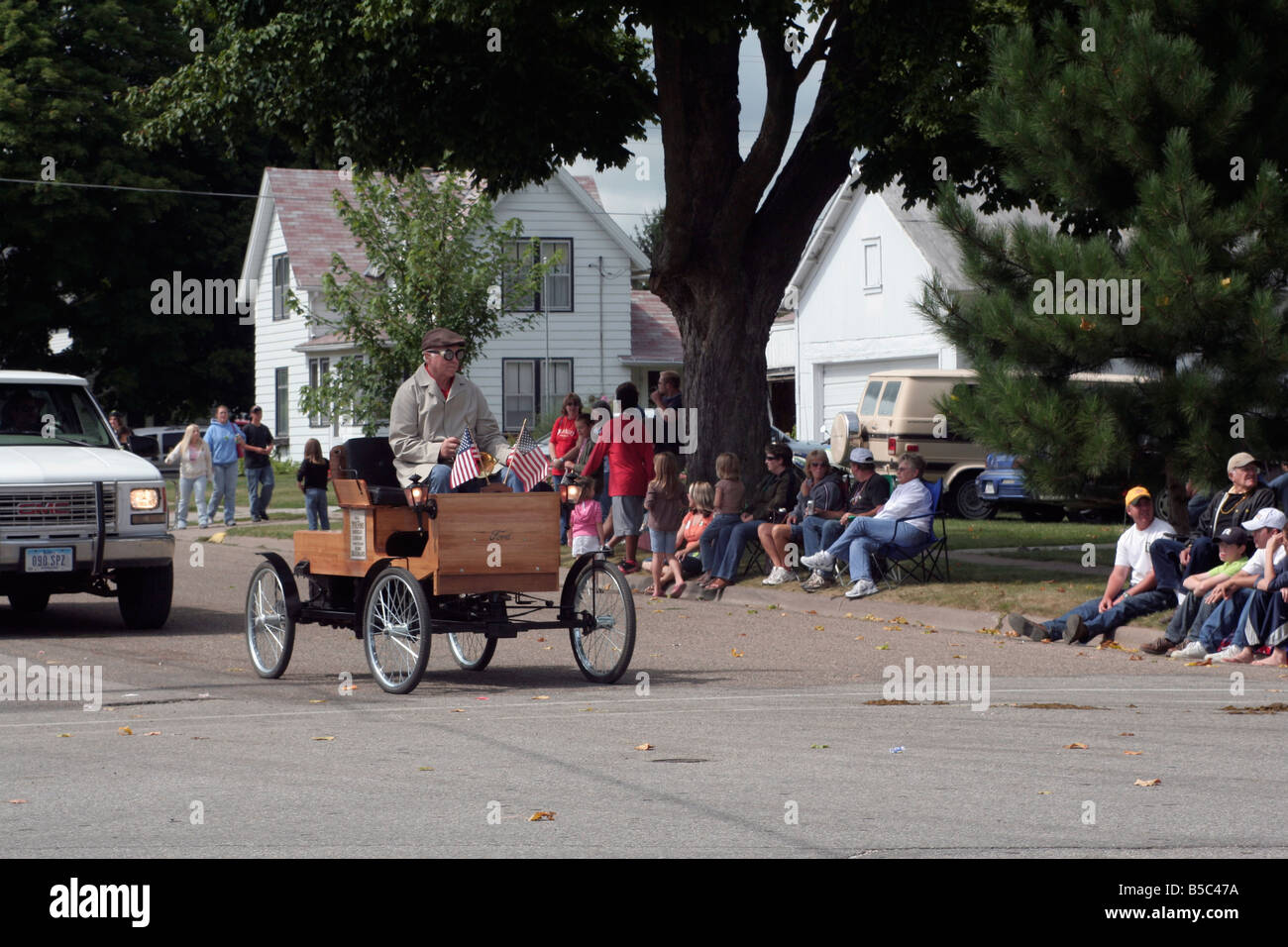 Old car replica in parade Stock Photo - Alamy