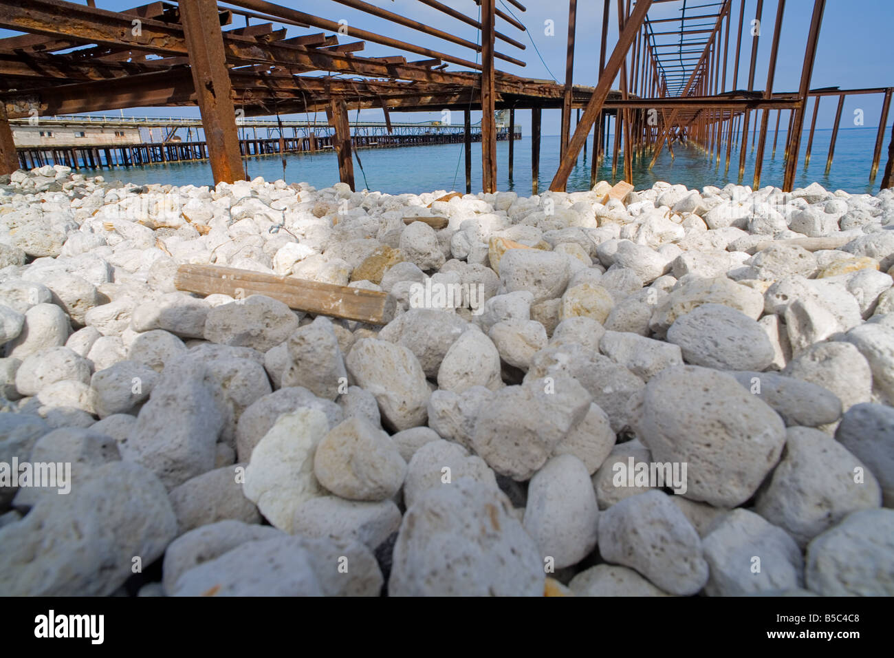White pumice stones and rusted piers at the pumice quarries at Lipari ...