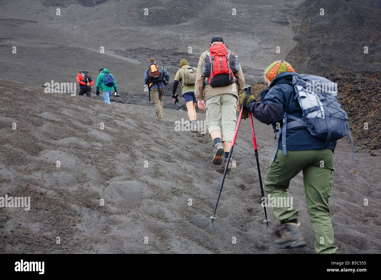 Group of hikers climbing Mt. Etna volcano Stock Photo - Alamy
