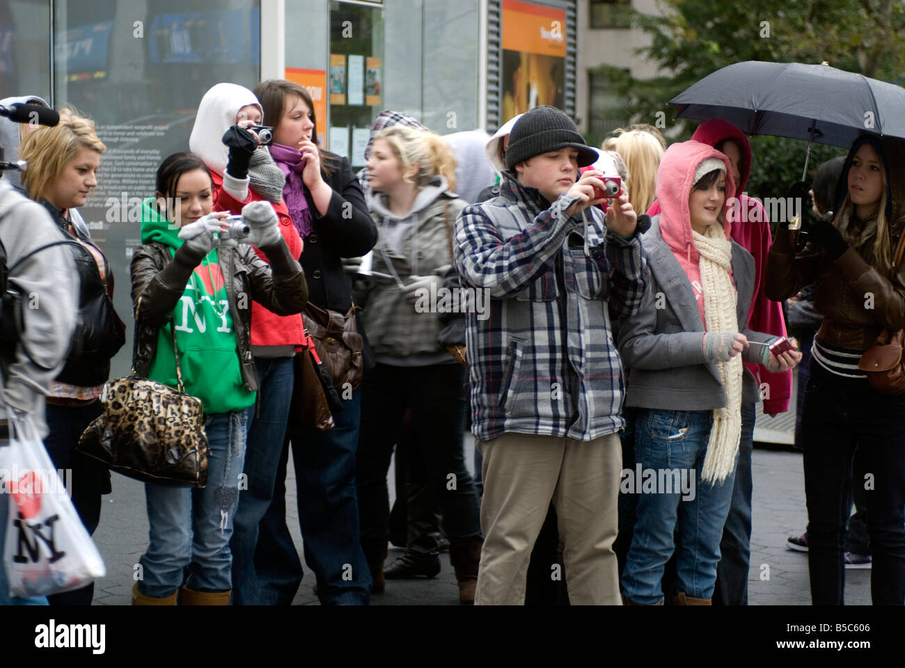A group of high school students photograph with their digital cameras ...