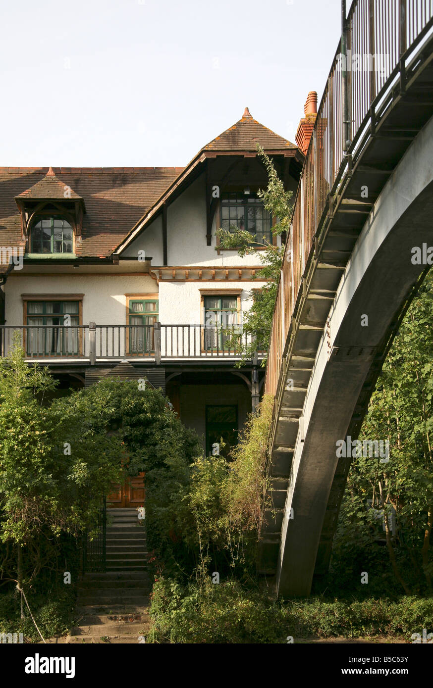 House facing footbridge and River Thames, Shepperton, England, low ...