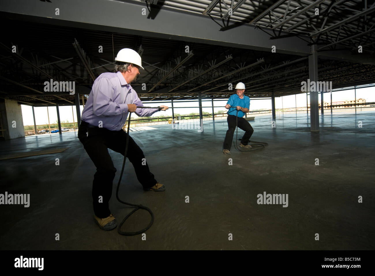 Two workers fighting Stock Photo - Alamy