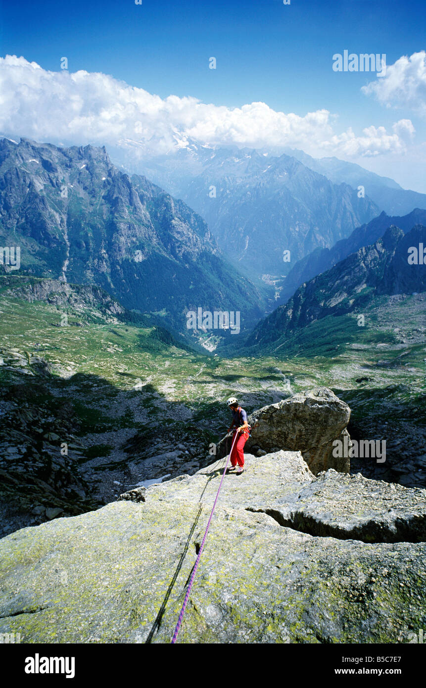 30 year old woman descending rappelling down a mountain side Stock ...