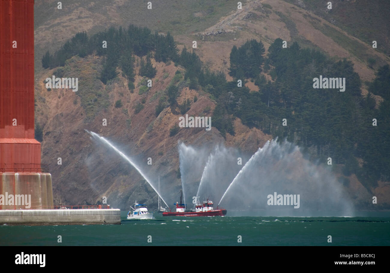 The Fireboat Phoenix leads the procession under the Golden Gate Bridge ...