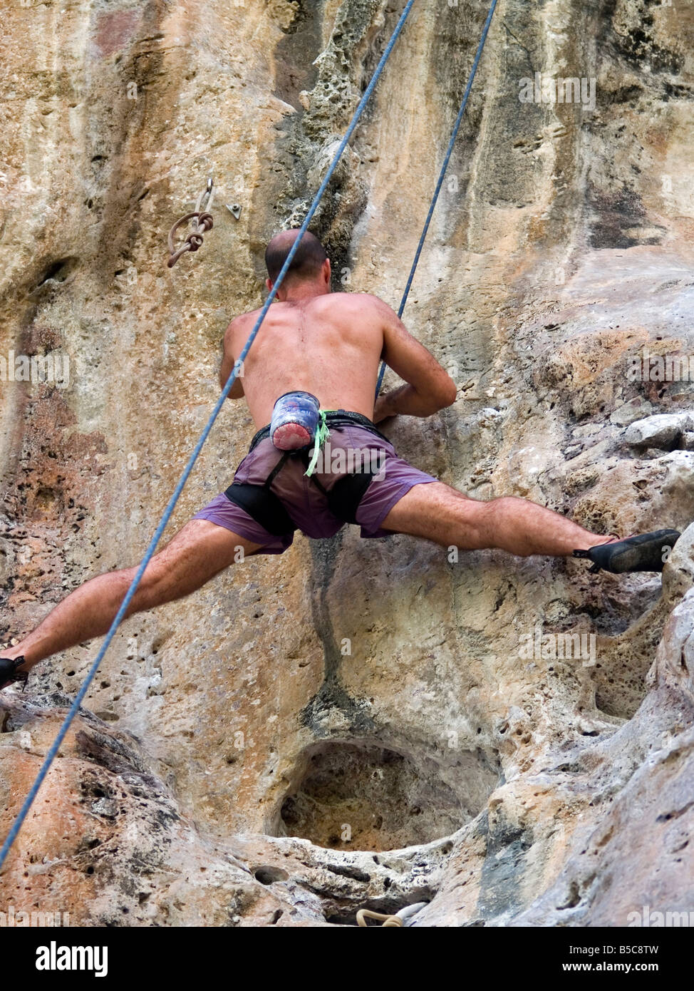 rock climber doing the splits on Rai Leh Beach in Krabi Thailand Stock ...