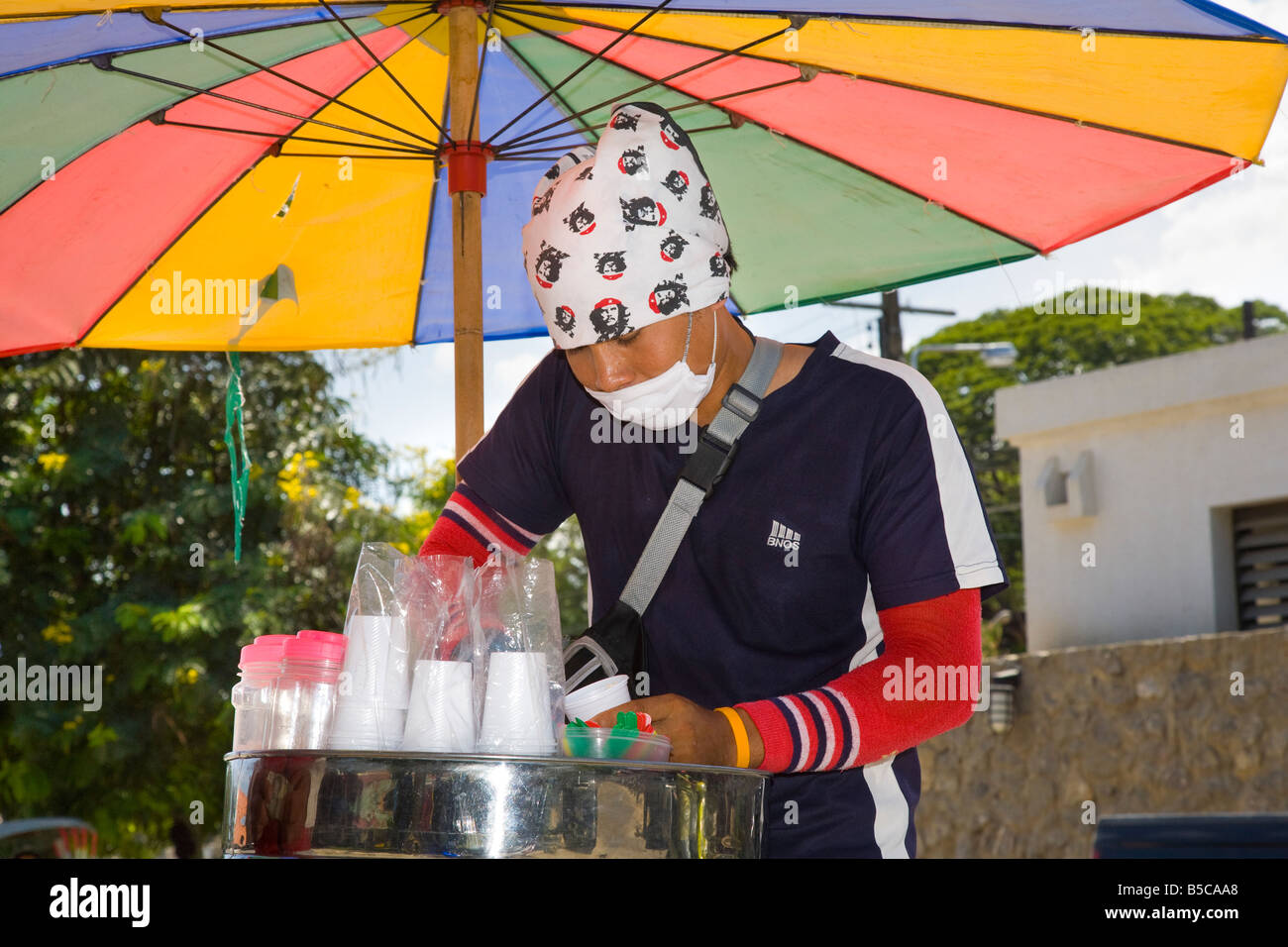 Mobile ice-cream vendor, selling ice cream, and wearing mask to provide ...